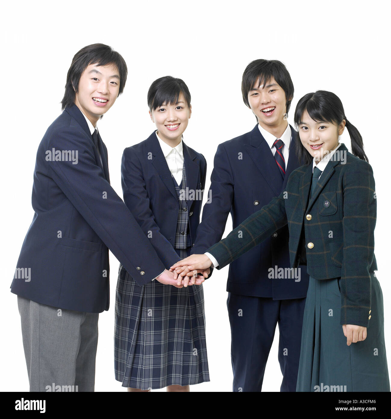 Four students are putting their hands together to cheer up Stock Photo ...