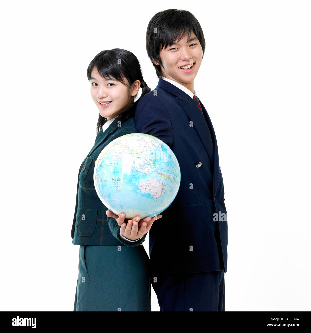 Two students are standing back to back, holding a globe together Stock ...