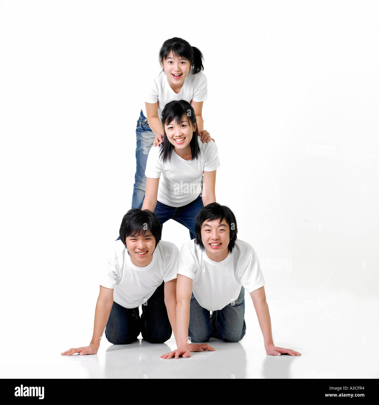 Teens making human pyramid Stock Photo - Alamy