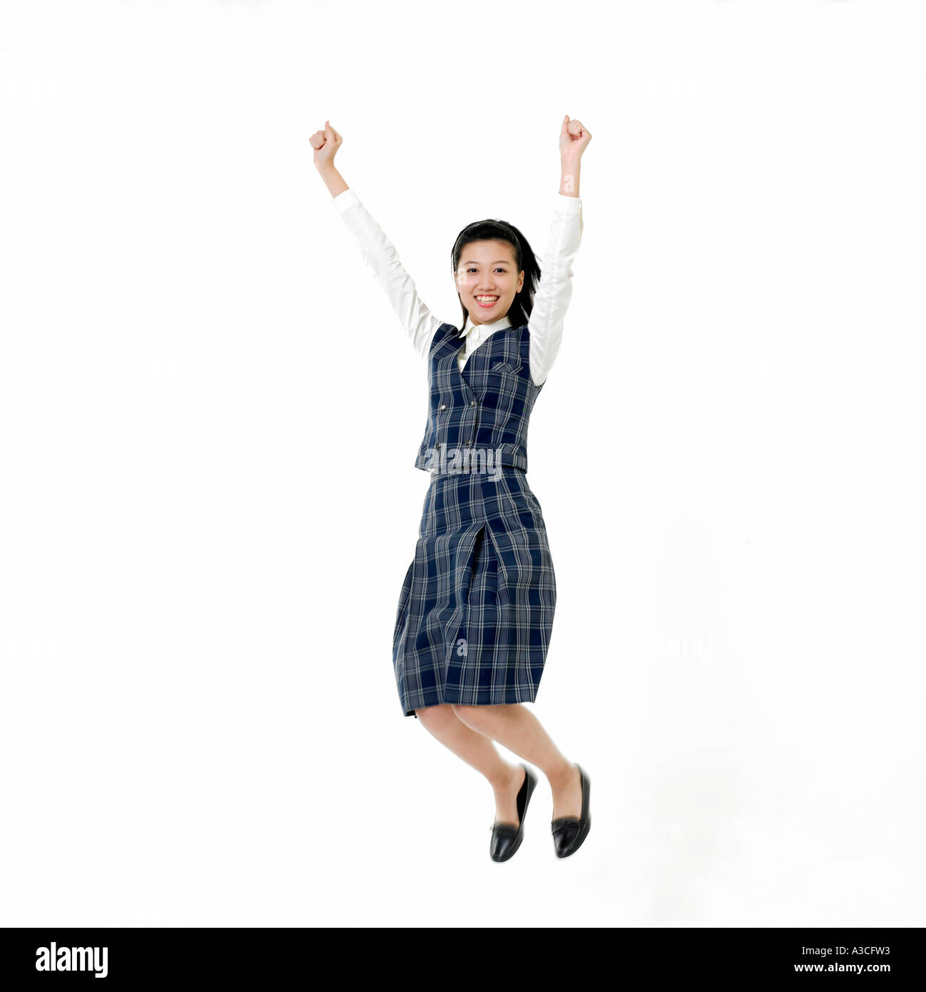 A girl in a school uniform is jumping high Stock Photo - Alamy