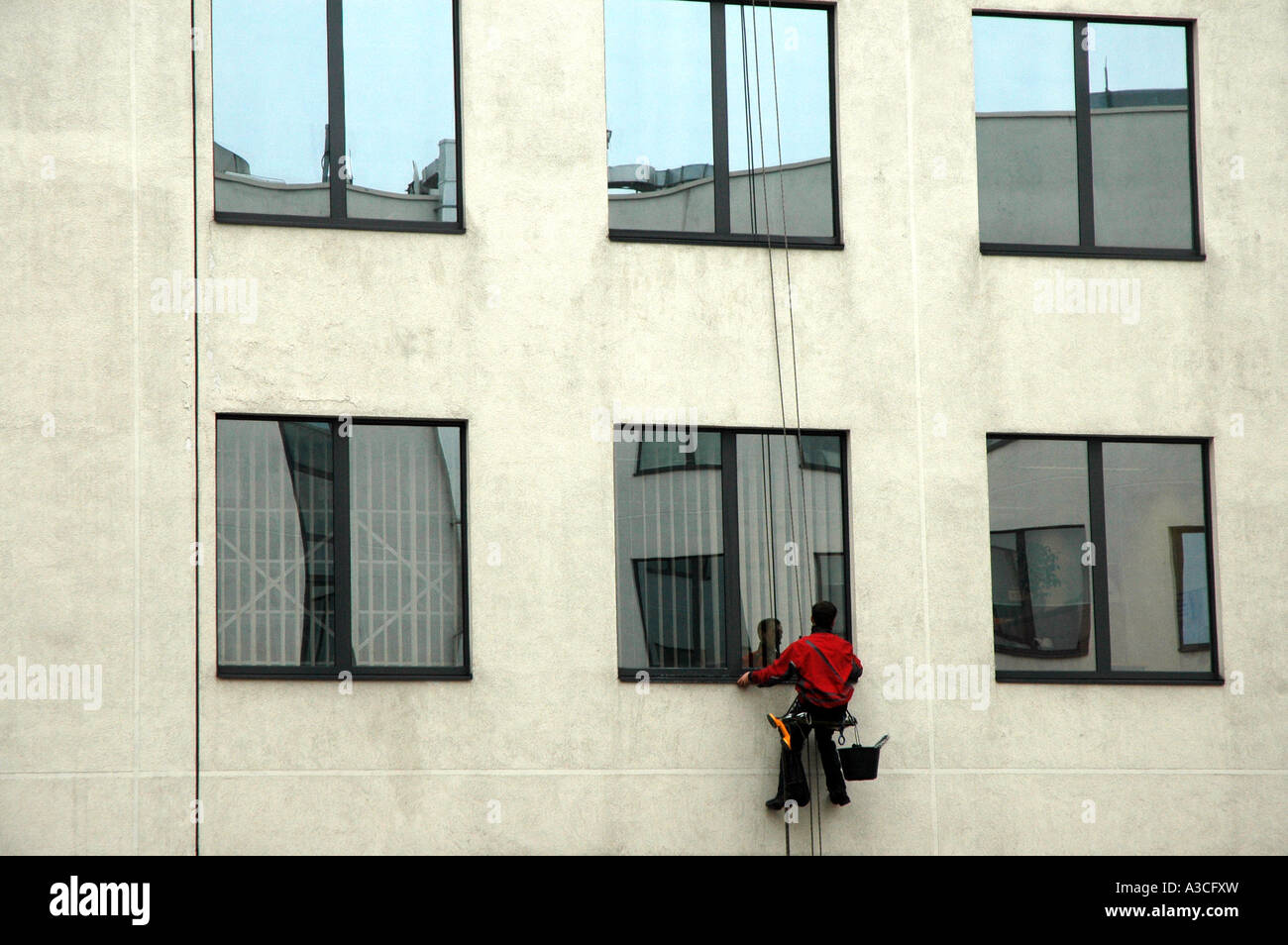 Window washer hanging on a rope in Warsaw, Poland Stock Photo - Alamy