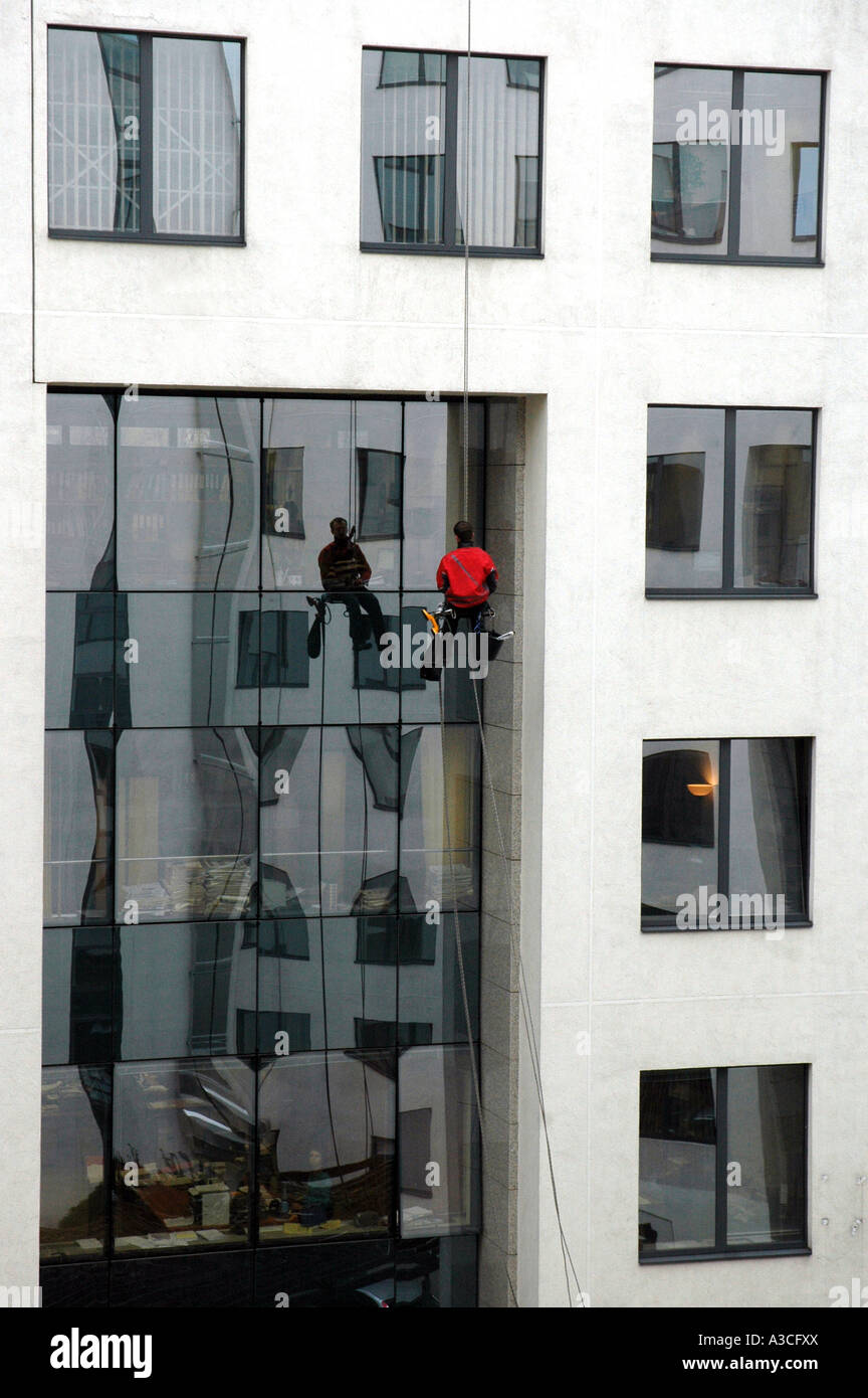 Window washer hanging on a rope in Warsaw, Poland Stock Photo - Alamy