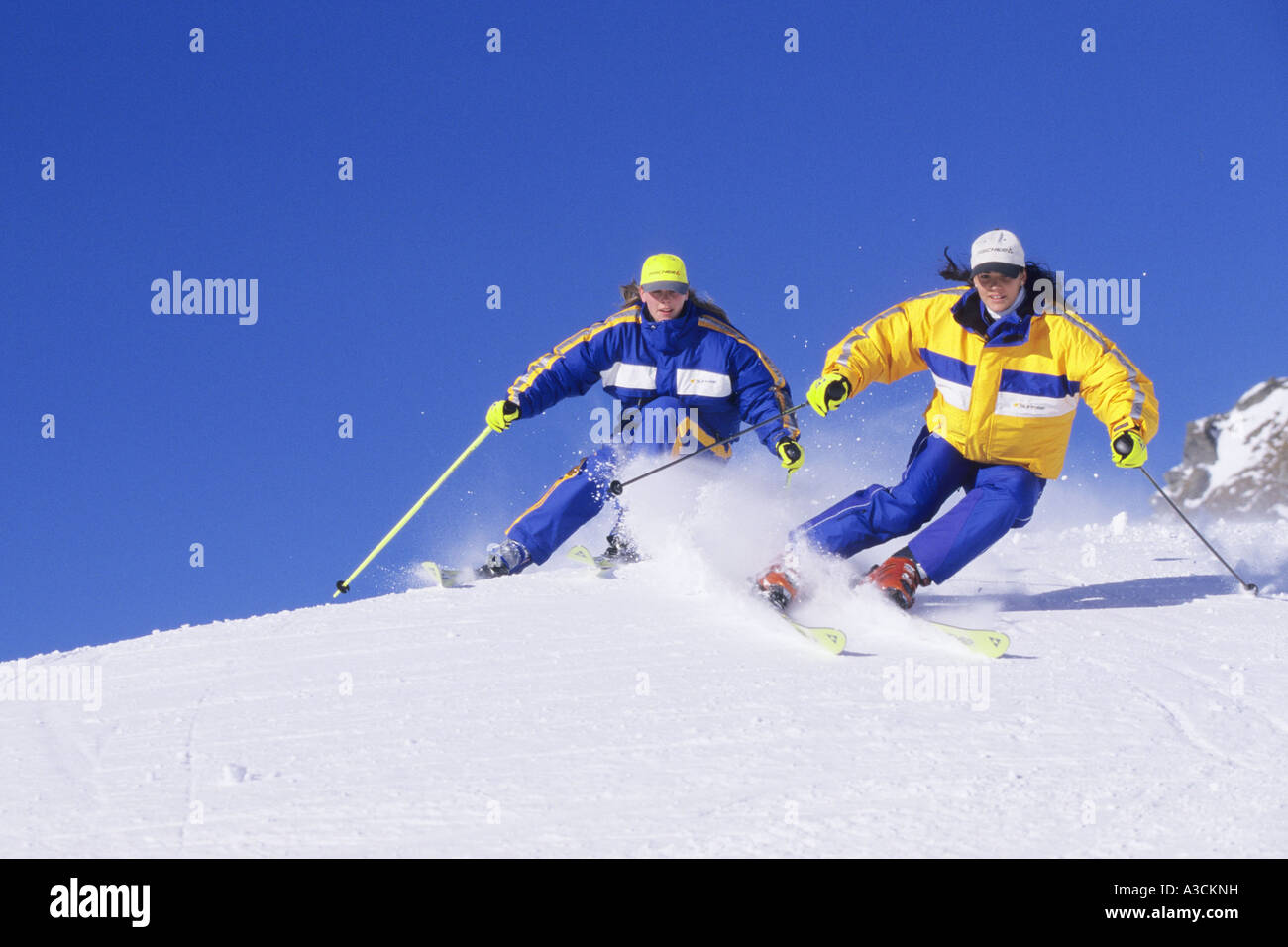 two female skier racing downhill, Austria, Alps Stock Photo - Alamy