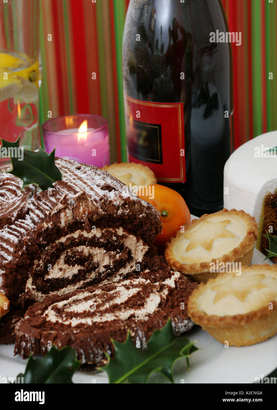 traditional christmas chocolate log and mince pies with candle Stock ...