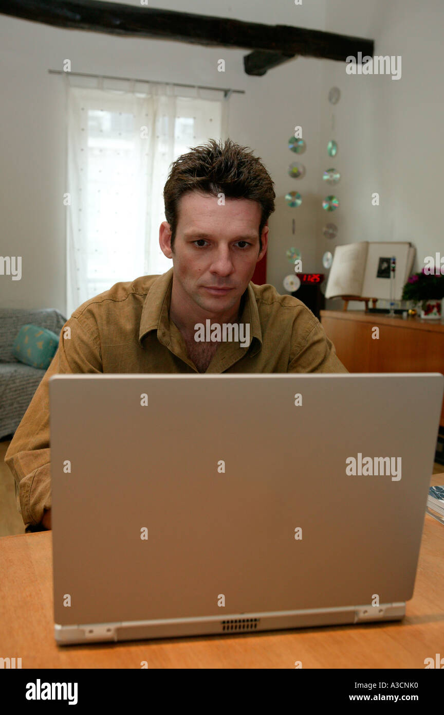 Man working at home on laptop computer Stock Photo - Alamy