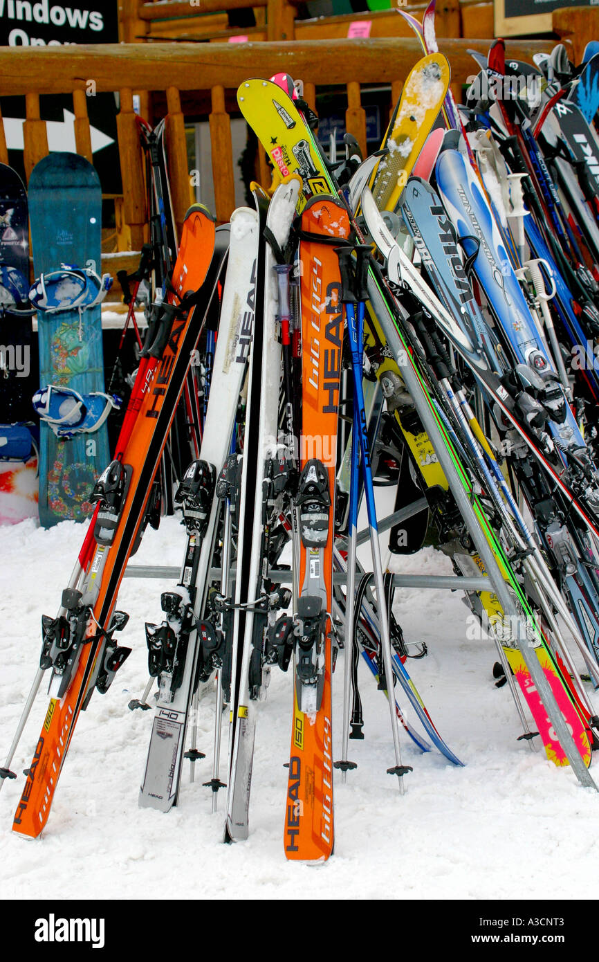 Ski rack full of skis and snowboards Stock Photo - Alamy