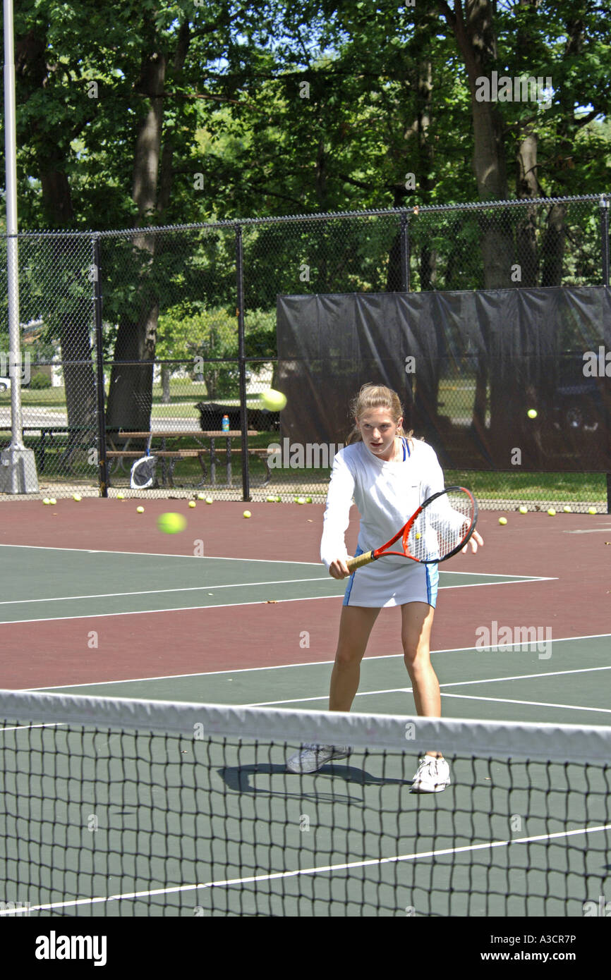 Teenage female High school student learns to play Tennis Stock Photo ...