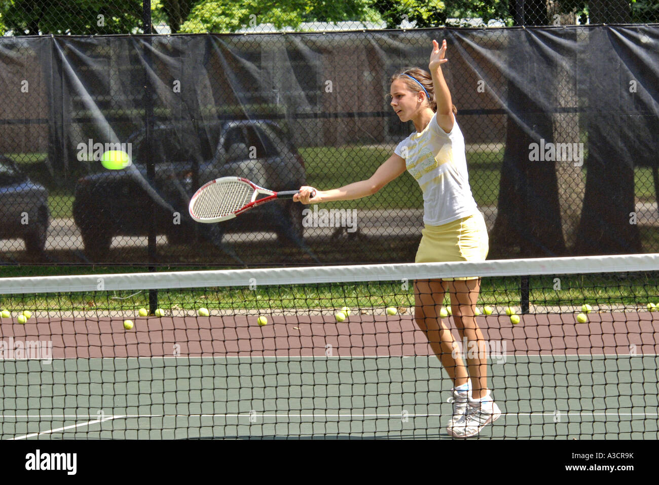 Teenage female student playing Tennis at an after-school club in ...