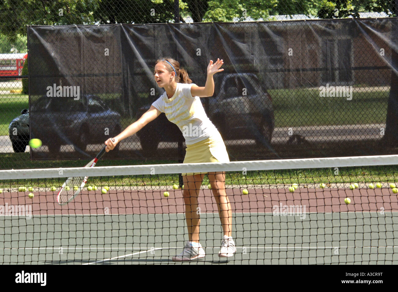 Teenage female student playing Tennis at an after-school club in ...