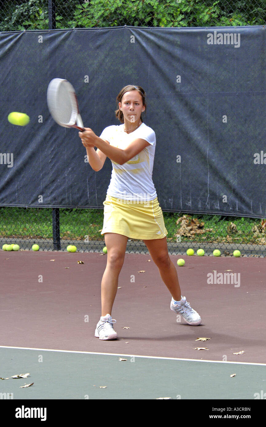 Teenage female student playing Tennis at an after-school club in ...