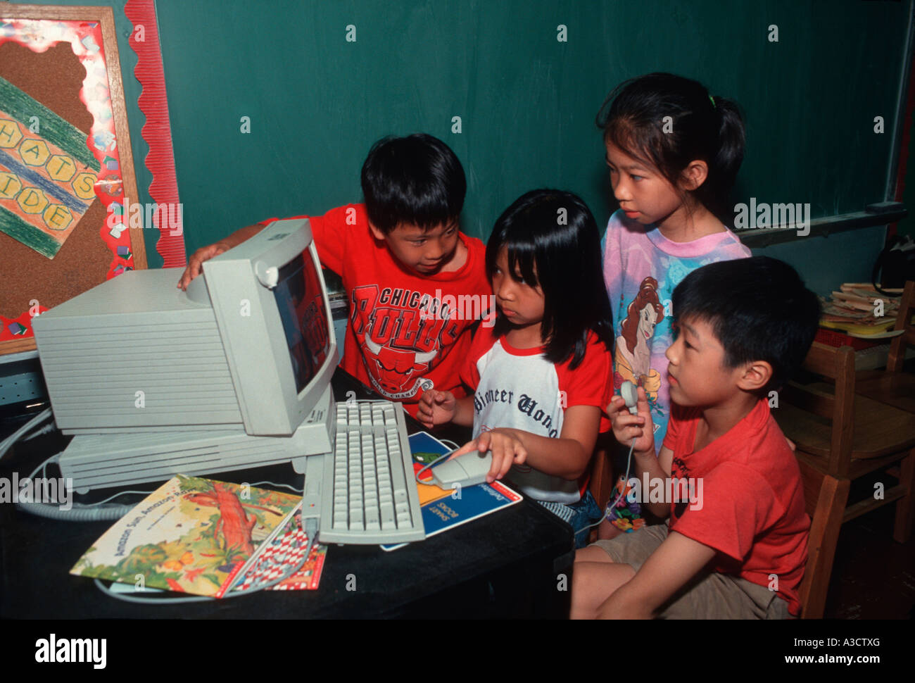 Children work together at a computer at an elementary school in the ...