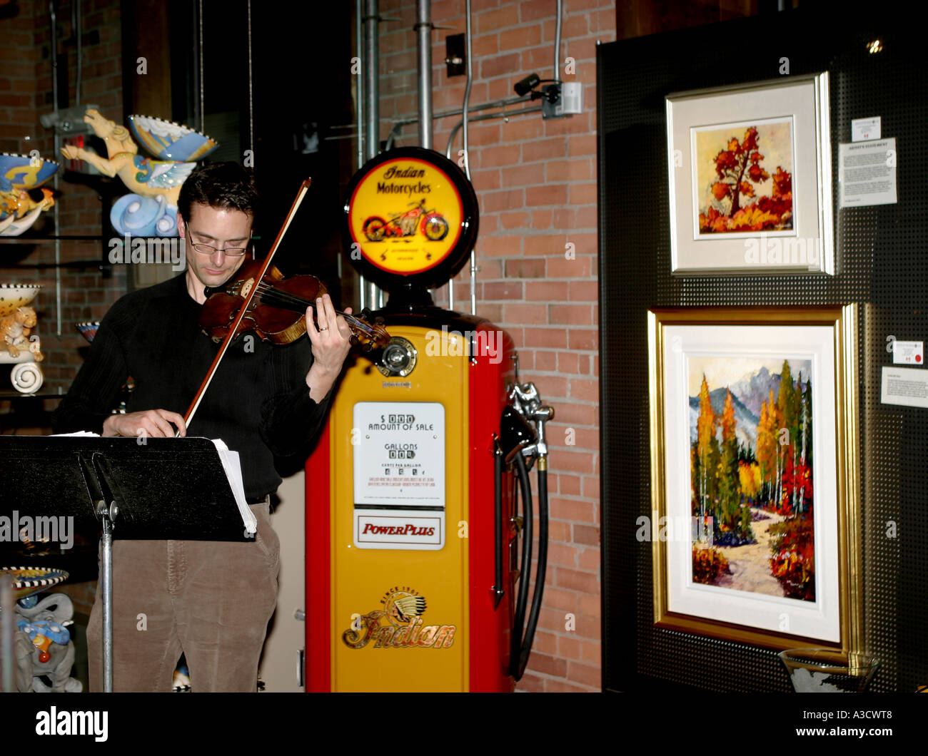 MUSICIAN entertaining at an art gallery show Stock Photo - Alamy
