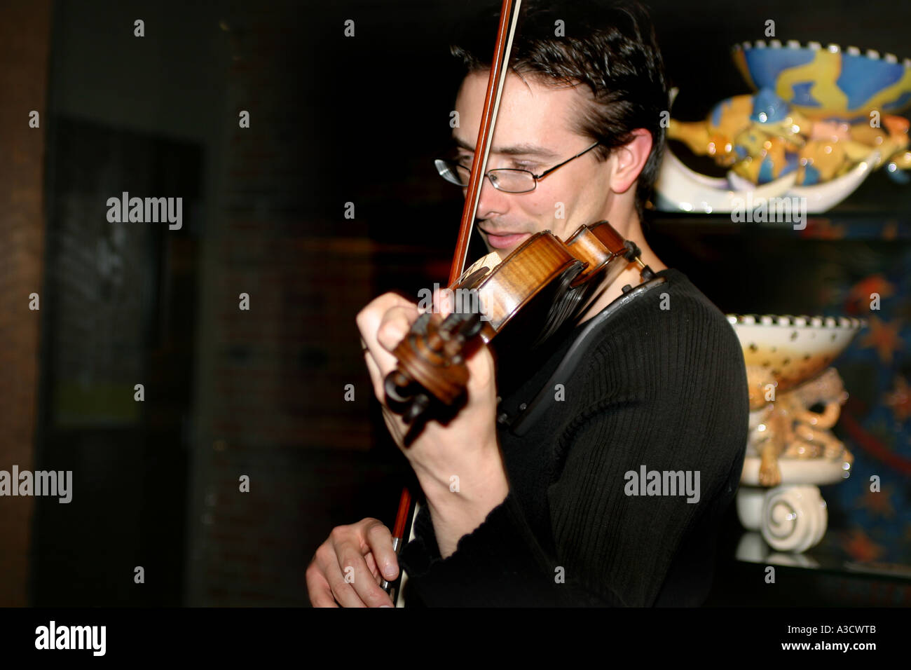 MUSICIAN entertaining at an art gallery show Stock Photo - Alamy