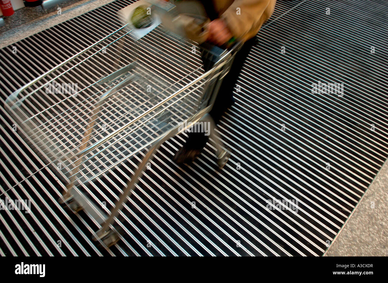 Shopping trolley runs over grating at supermarket entrance Stock Photo ...