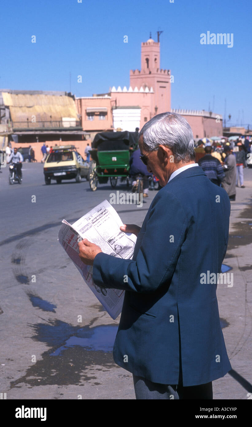 Smart Moroccan gentleman reading Arabic newspaper in the Place Djemaa ...