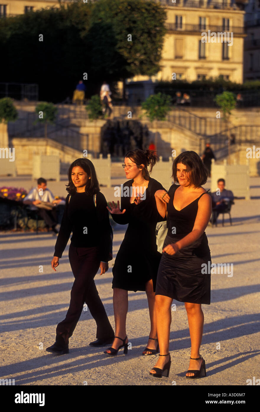 3 three French women friends getting together walking in Tuileries ...