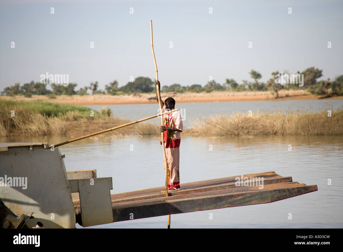 Boy stood on the ferry crossing the Bani river on route to the Monday ...