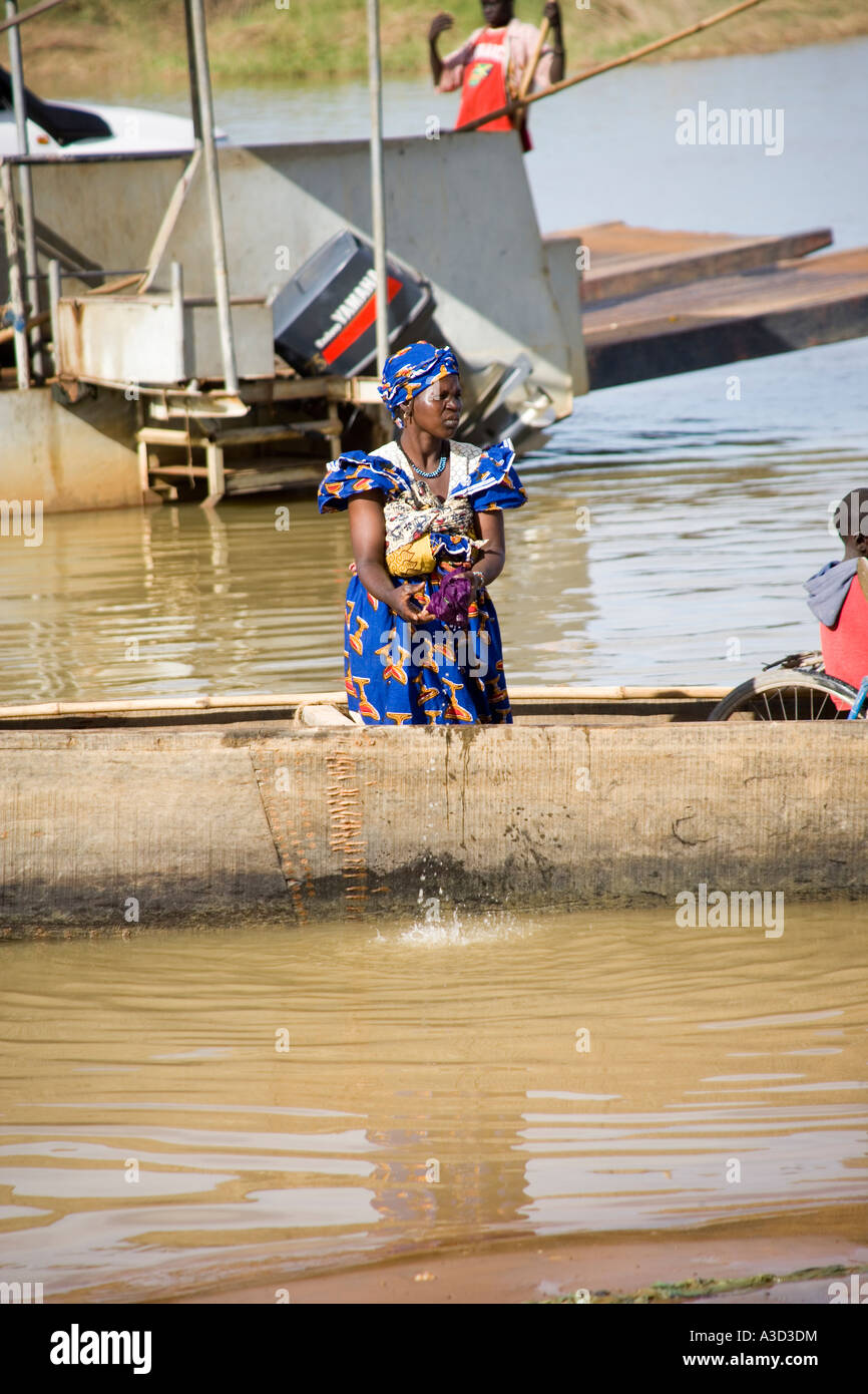 Woman washing clothes in the Bani river from a pirogue canoe near ...