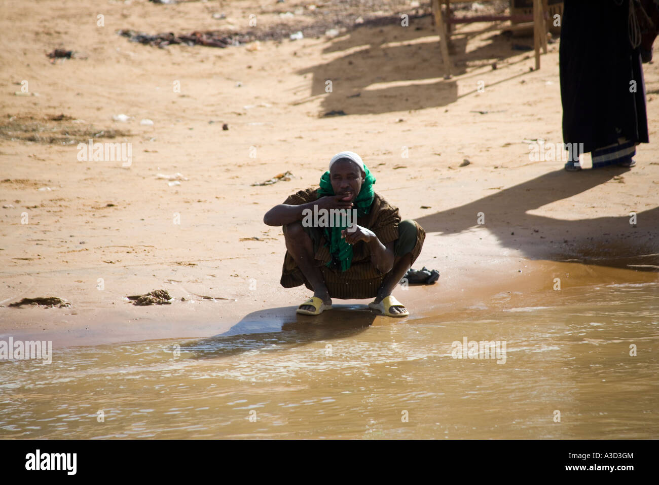 Man on the edge of the Bani river near Djenne from the ferry on route ...