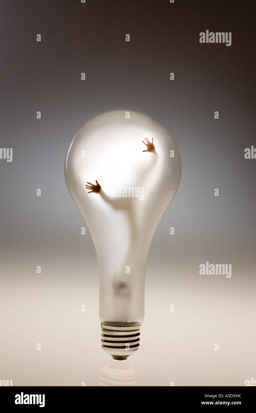 Hands inside light bulb trying to get out Stock Photo - Alamy