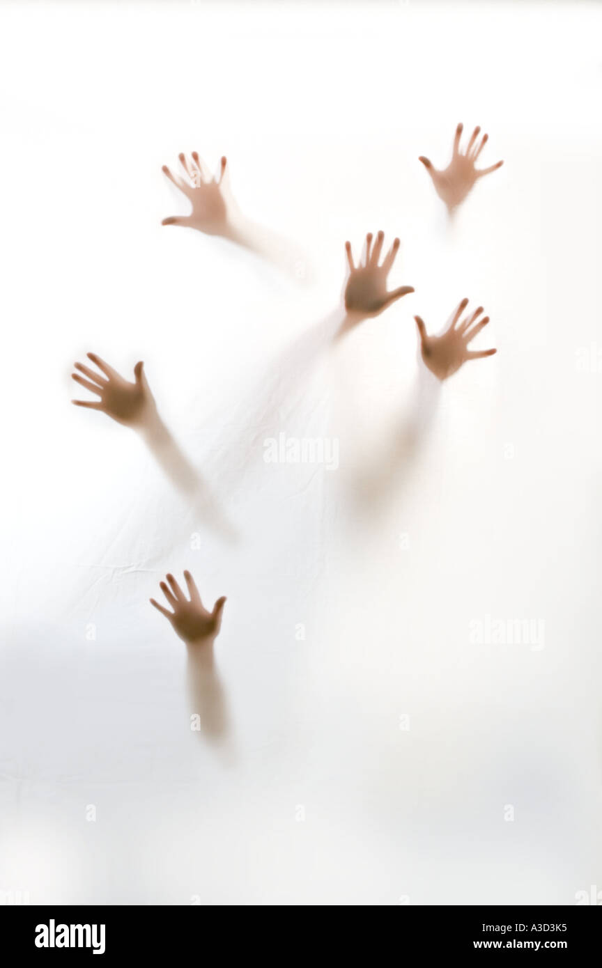 Hands trying to reach through a barrier Stock Photo - Alamy