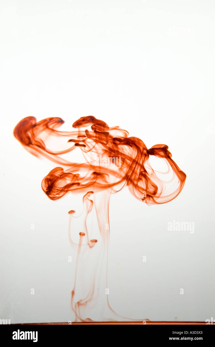 Drop of red dye into water Stock Photo - Alamy