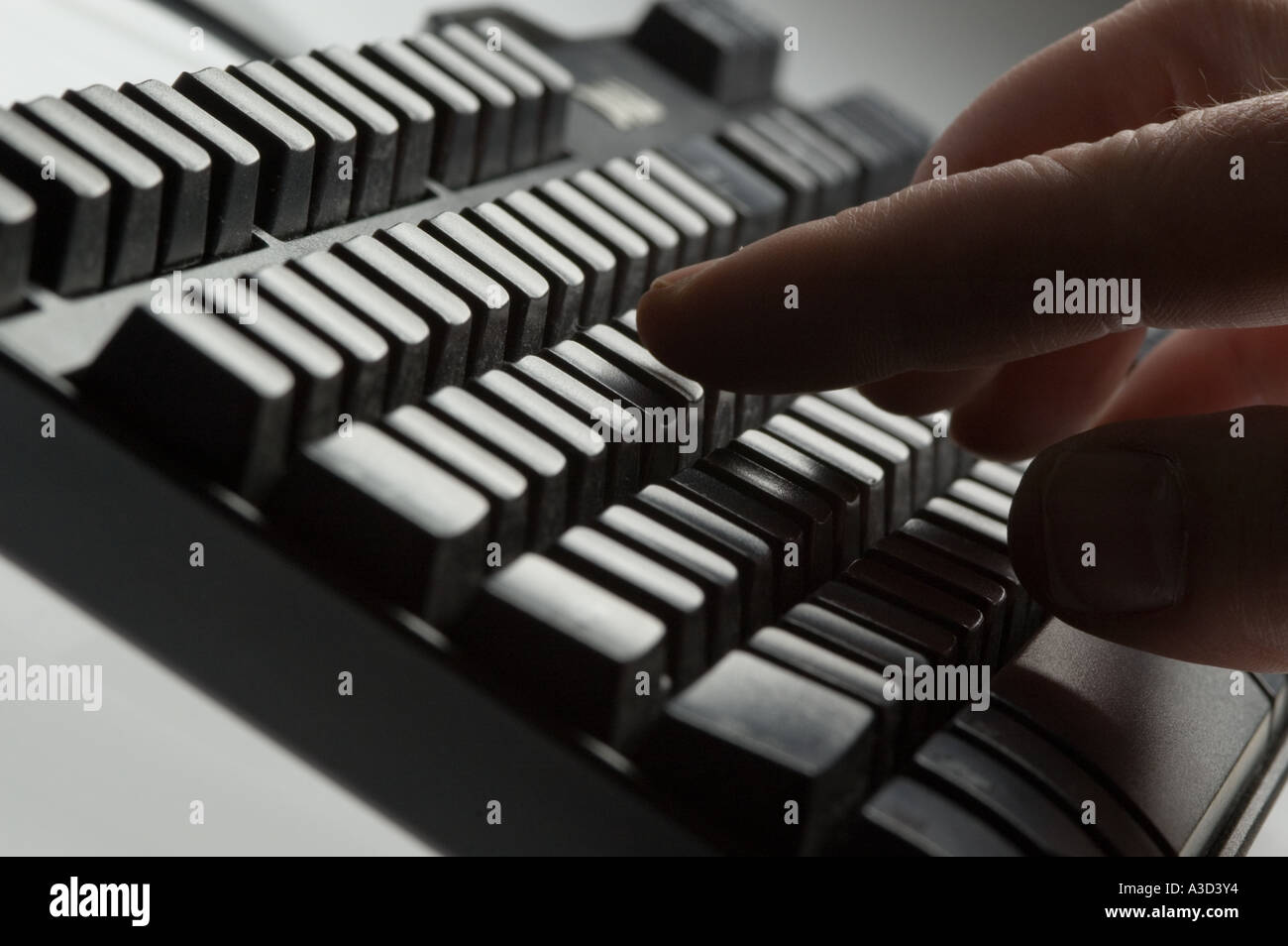 Pressing keys on computer keyboard Stock Photo - Alamy
