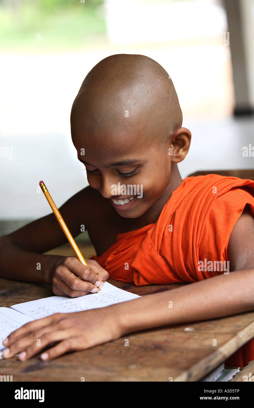 Vertical close up portrait of young student Buddhist monk in school at ...