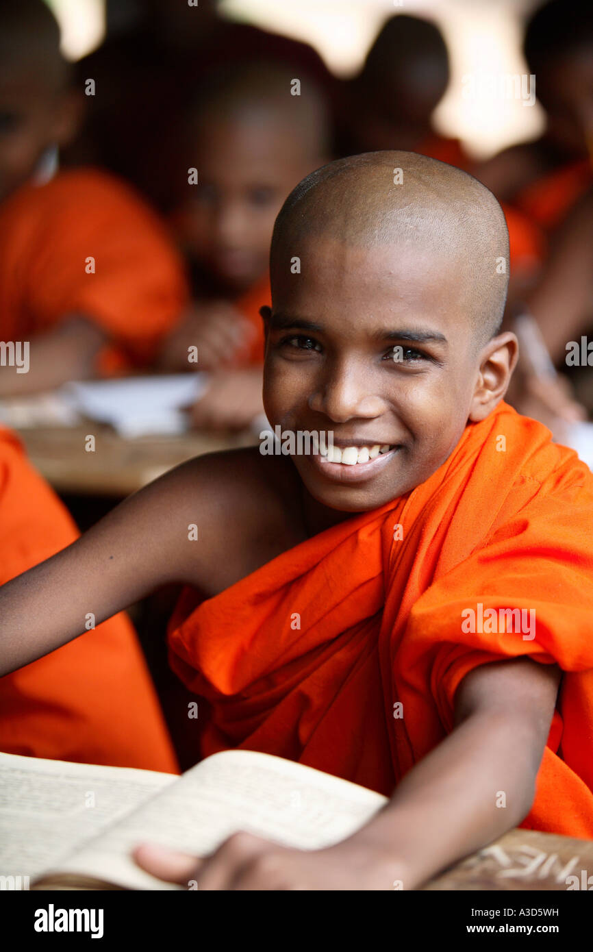 Vertical close up portrait of young student Buddhist monk in school at ...