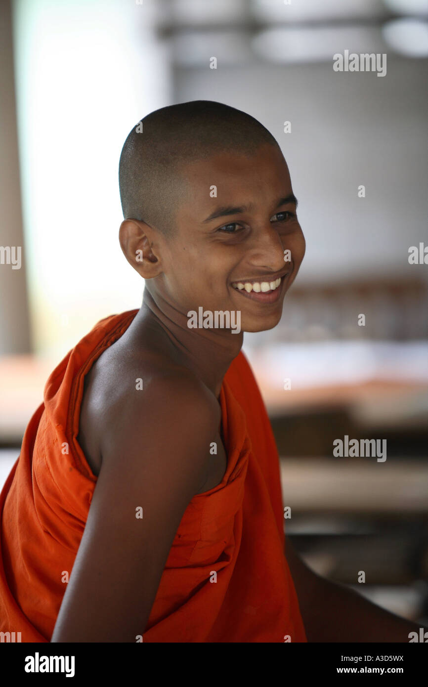 Close up portrait of young student Buddhist monk in traditional robes ...