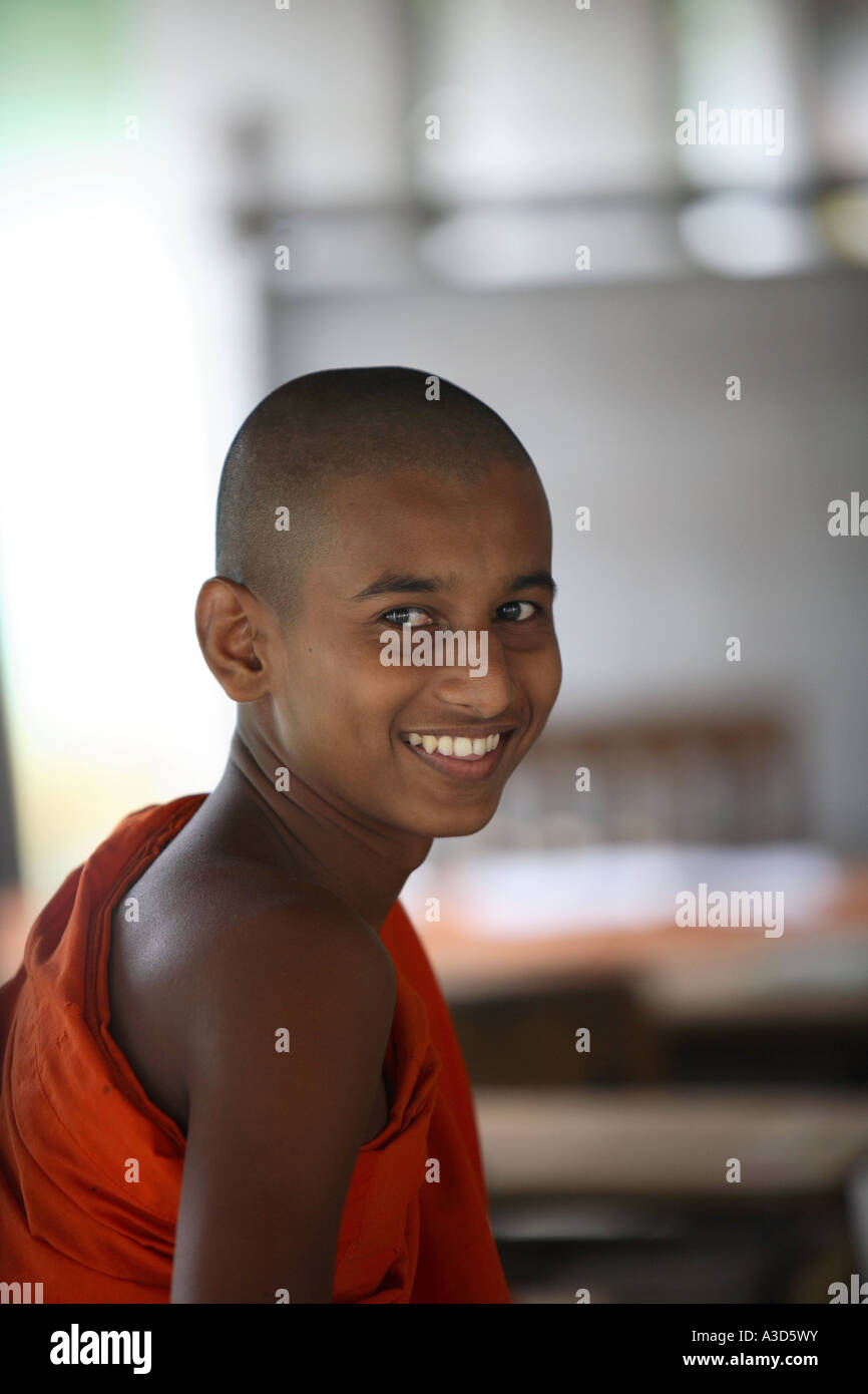 Close up portrait of young student Buddhist monk in traditional robes ...