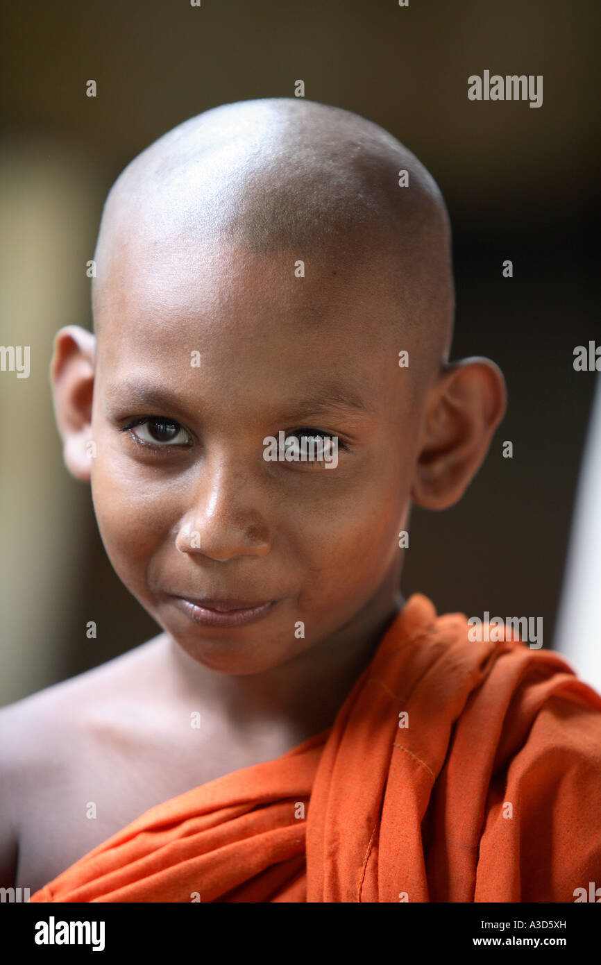 Close up portrait of young student Buddhist monk in traditional robes ...