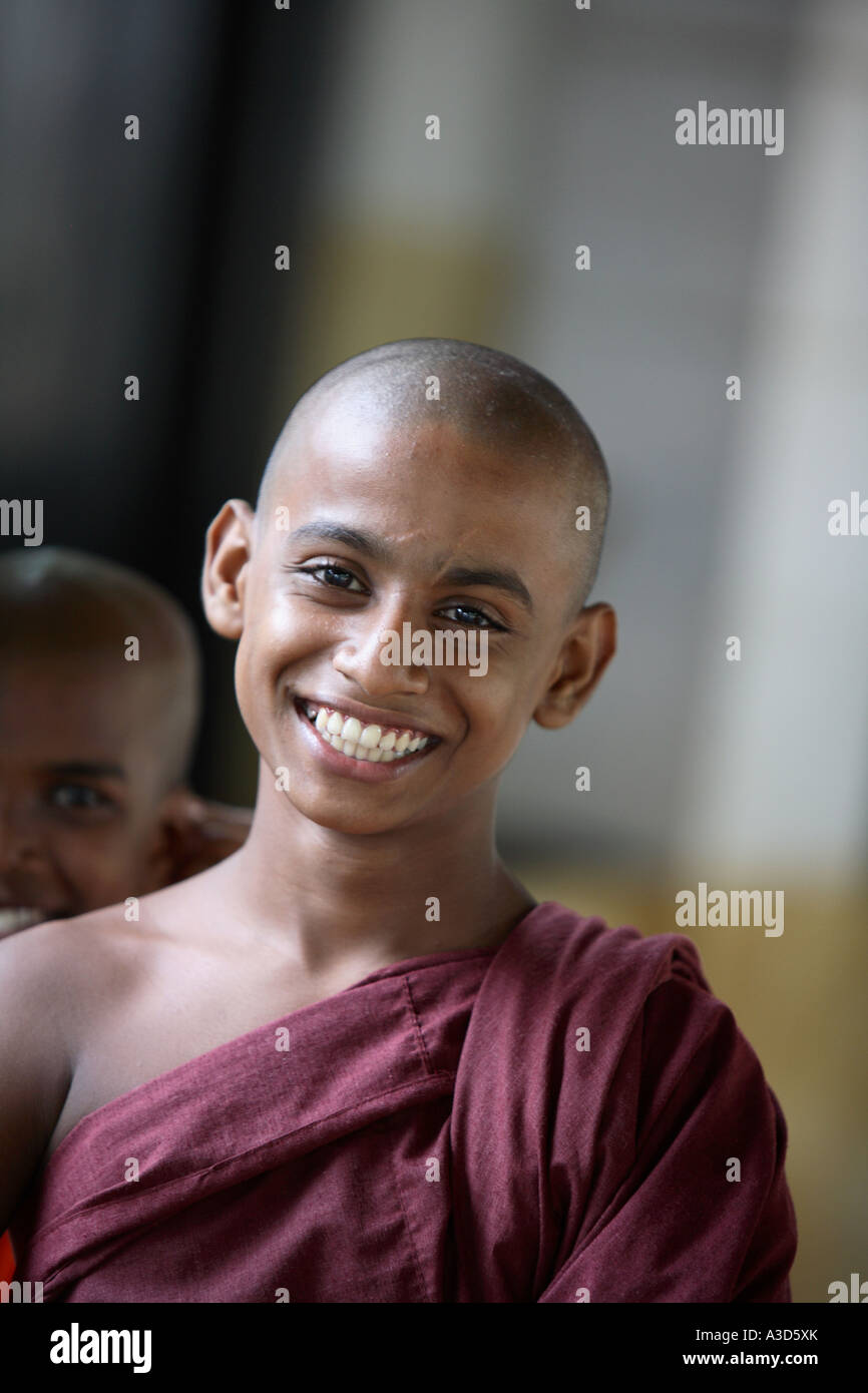 Close up portrait of young student Buddhist monk in traditional robes ...