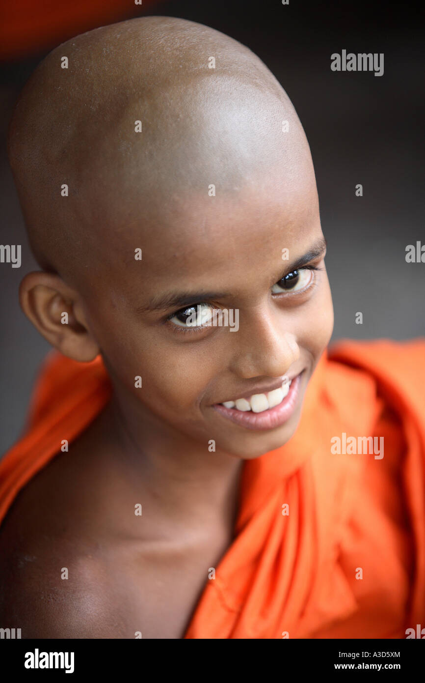 Close up portrait of young student Buddhist monk in traditional robes ...