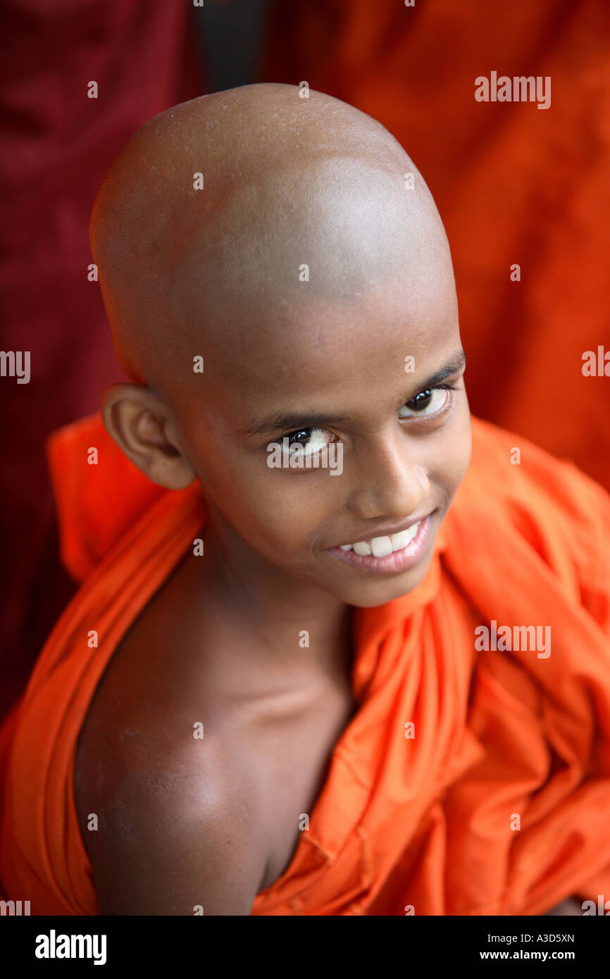 Close up portrait of young student Buddhist monk in traditional robes ...