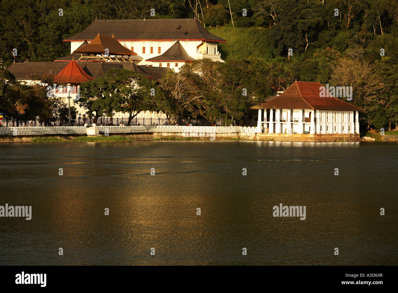 Horizontal early morning landscape of the Temple of the Tooth, on shore ...