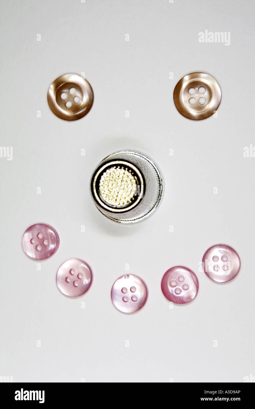 Face made from buttons and thimble Stock Photo - Alamy