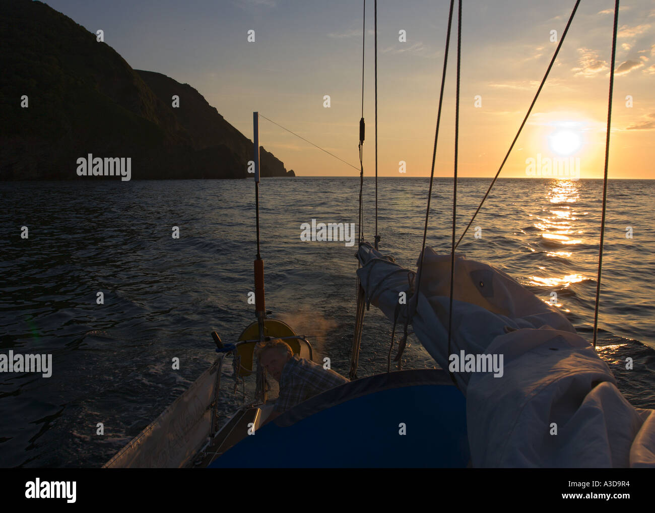 Soft gentle sunset on the Bristol Channel over bow of sailing boat ...