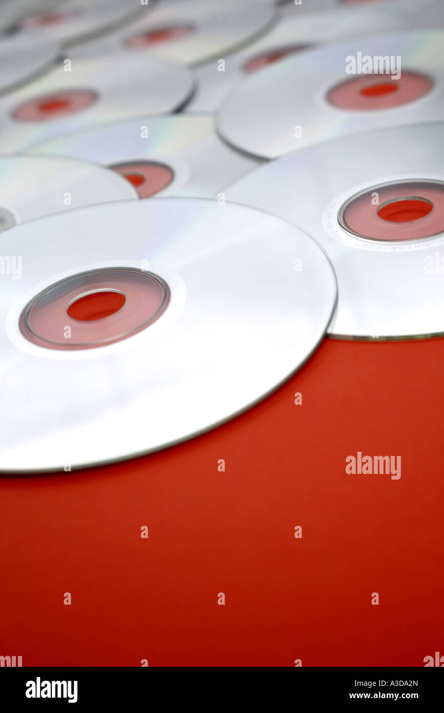 Cd's on red background Stock Photo - Alamy