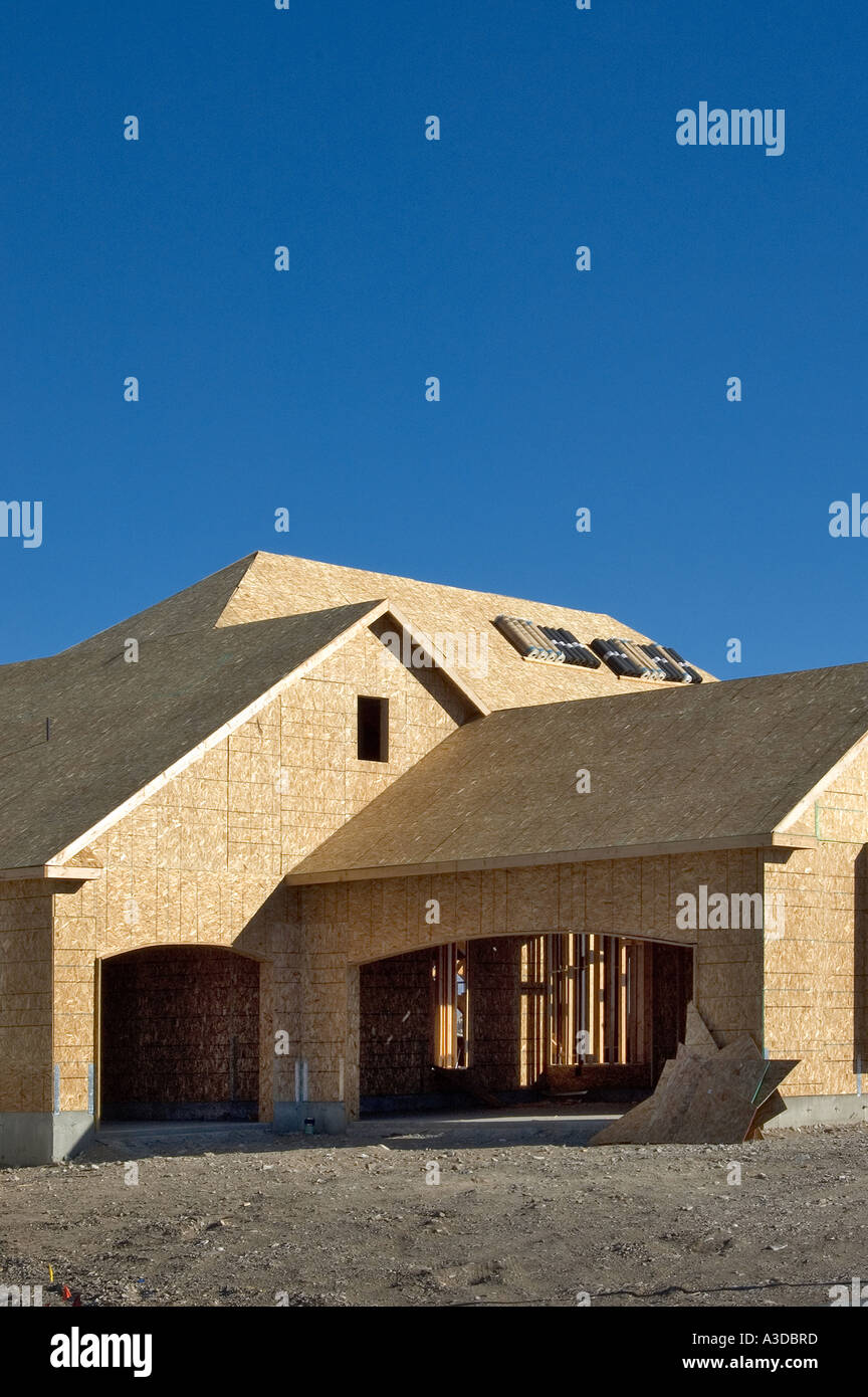 roofing materials wait on the sheeted roof for work crews to install a ...