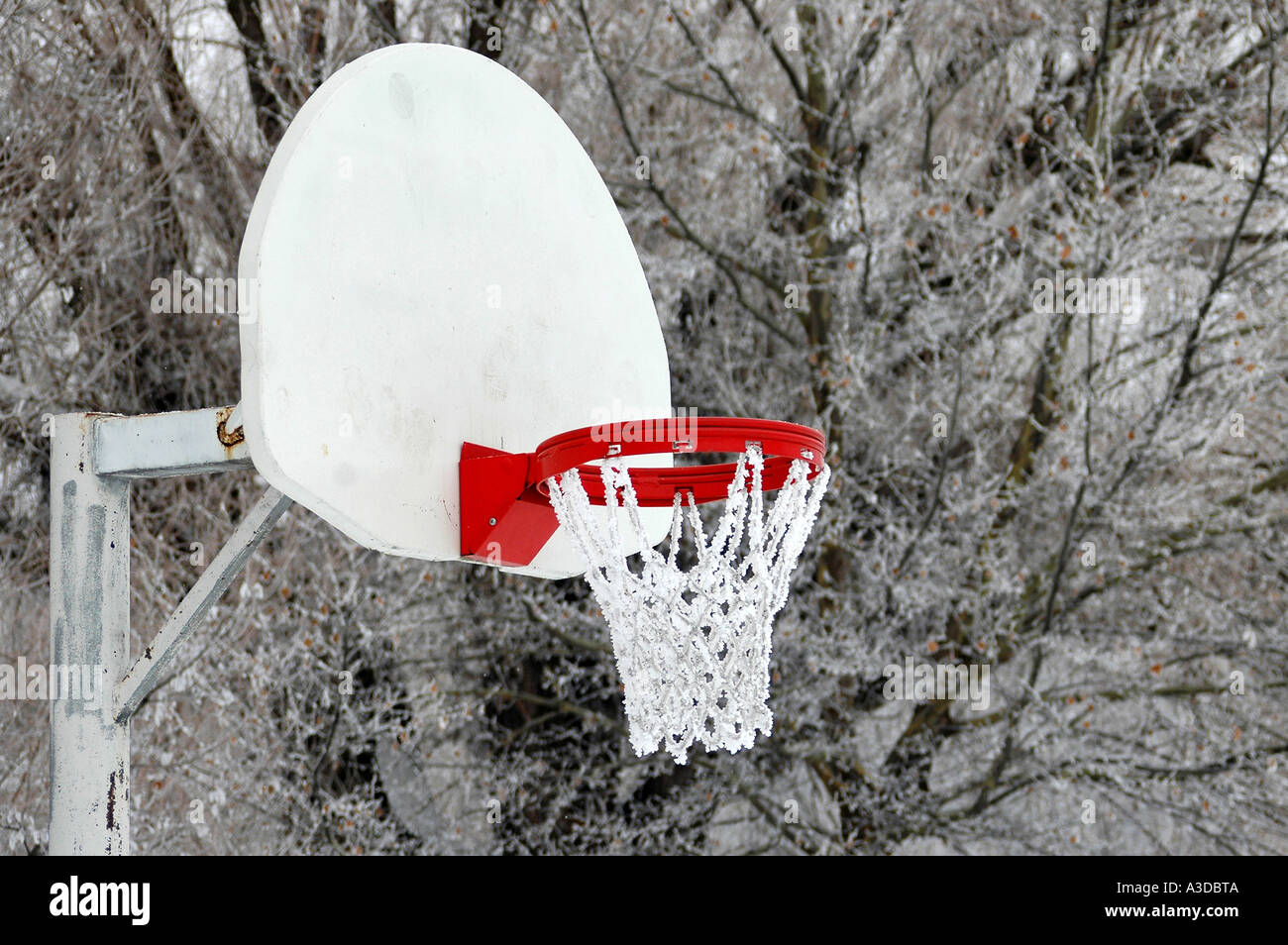 Outdoor basketball backboard in a park during the winter with frost ...
