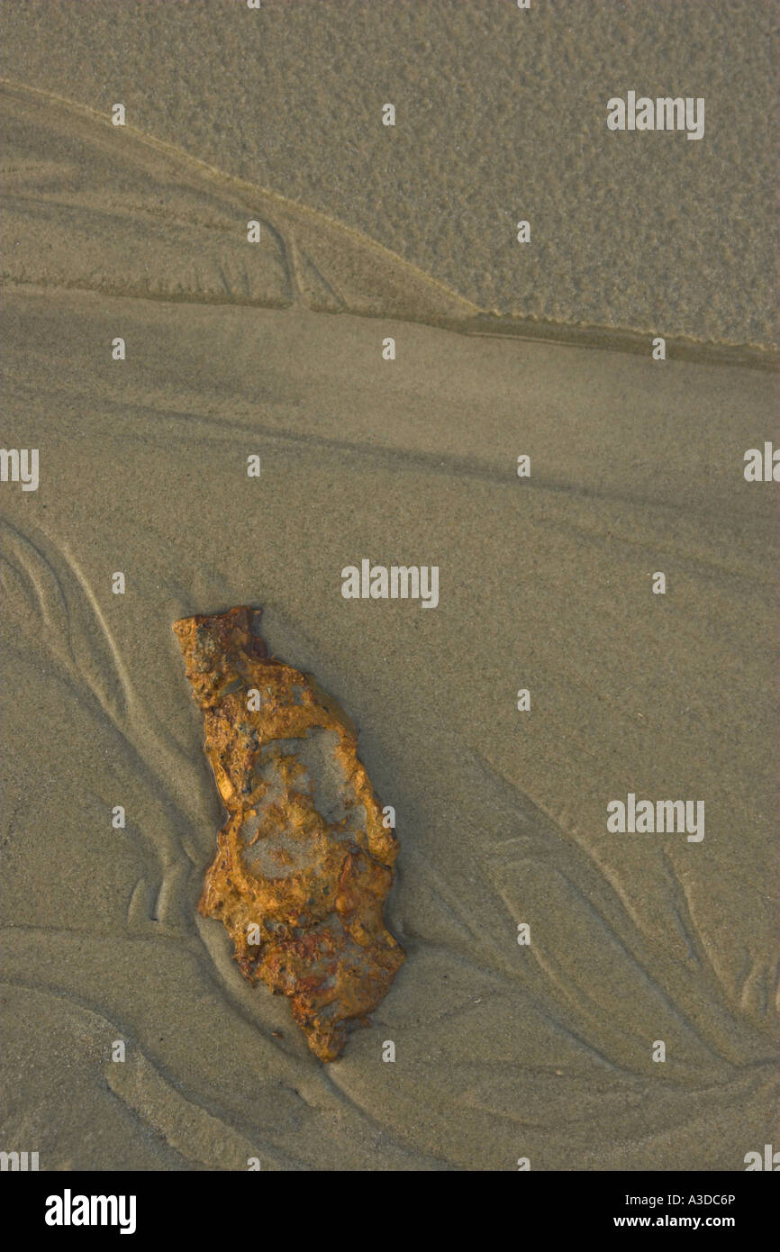 Concept / abstract - A rusting piece of metal on a sandy beach Stock ...