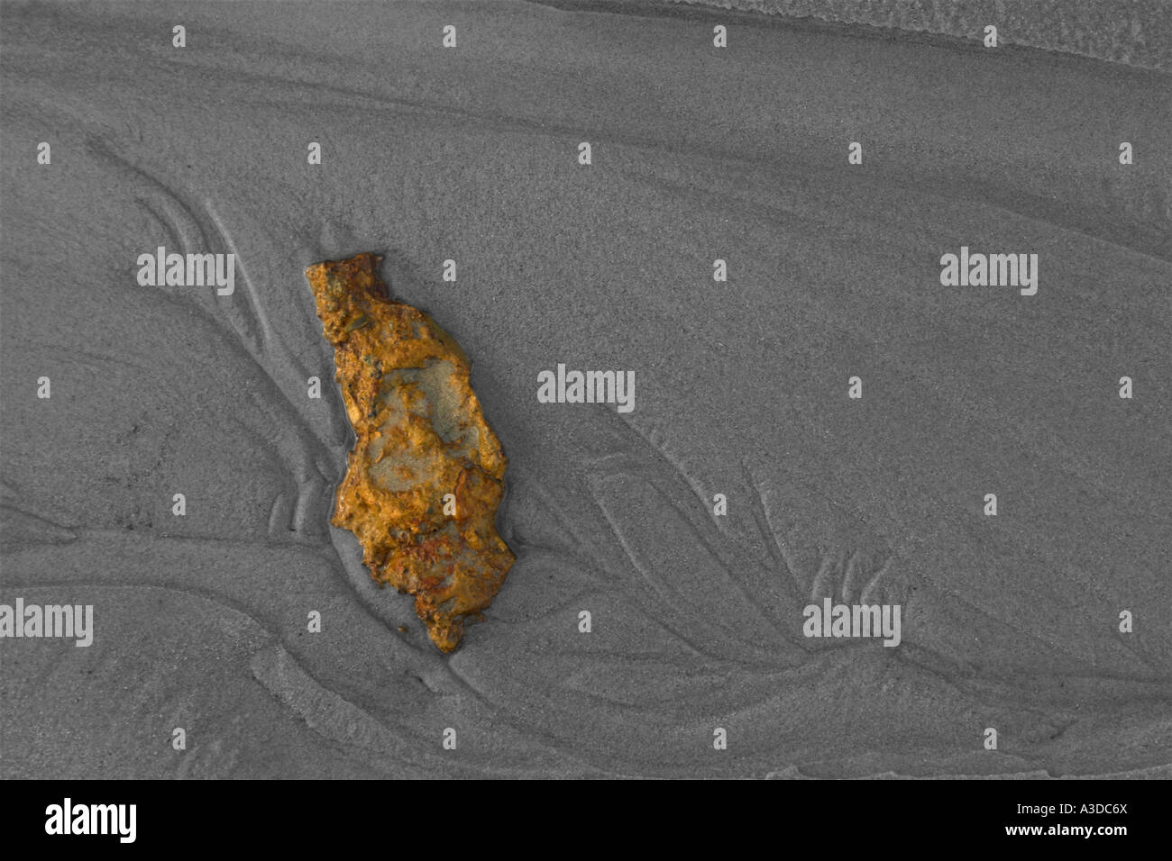 Concept / abstract - A rusting piece of metal on a sandy beach Stock ...