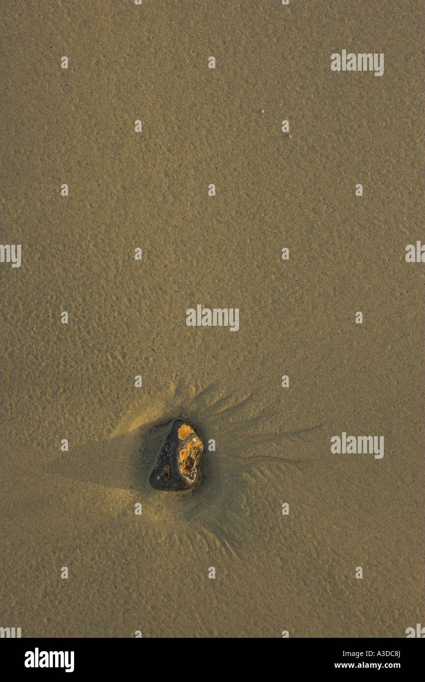 Abstract / concept - stone and 'star' pattern in sand Stock Photo - Alamy