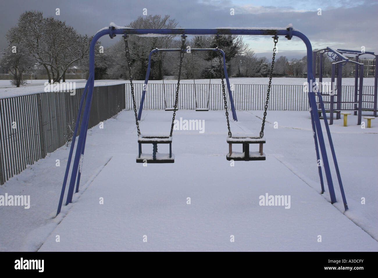 Snow covered swings Stock Photo - Alamy