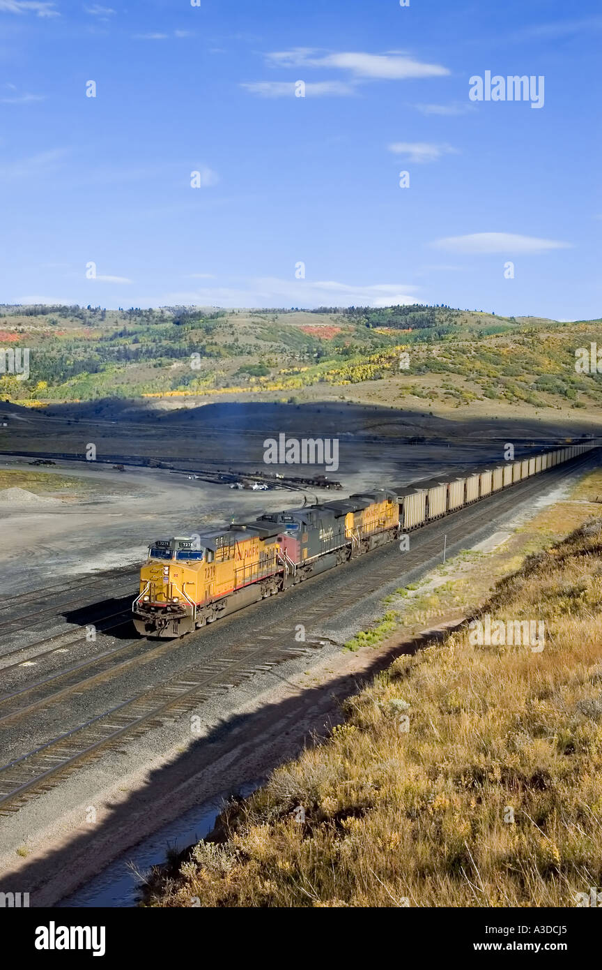 Loaded coal train stretches back from the engines as it crosses through ...