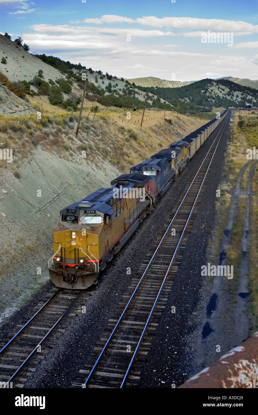 Loaded coal train stretches back from the engines as it passes ...