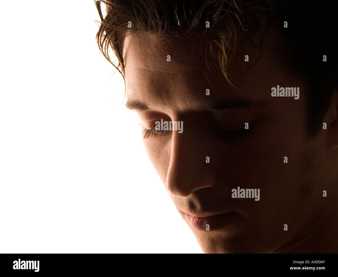 Portrait of a young thoughtful man in the backlight Stock Photo - Alamy