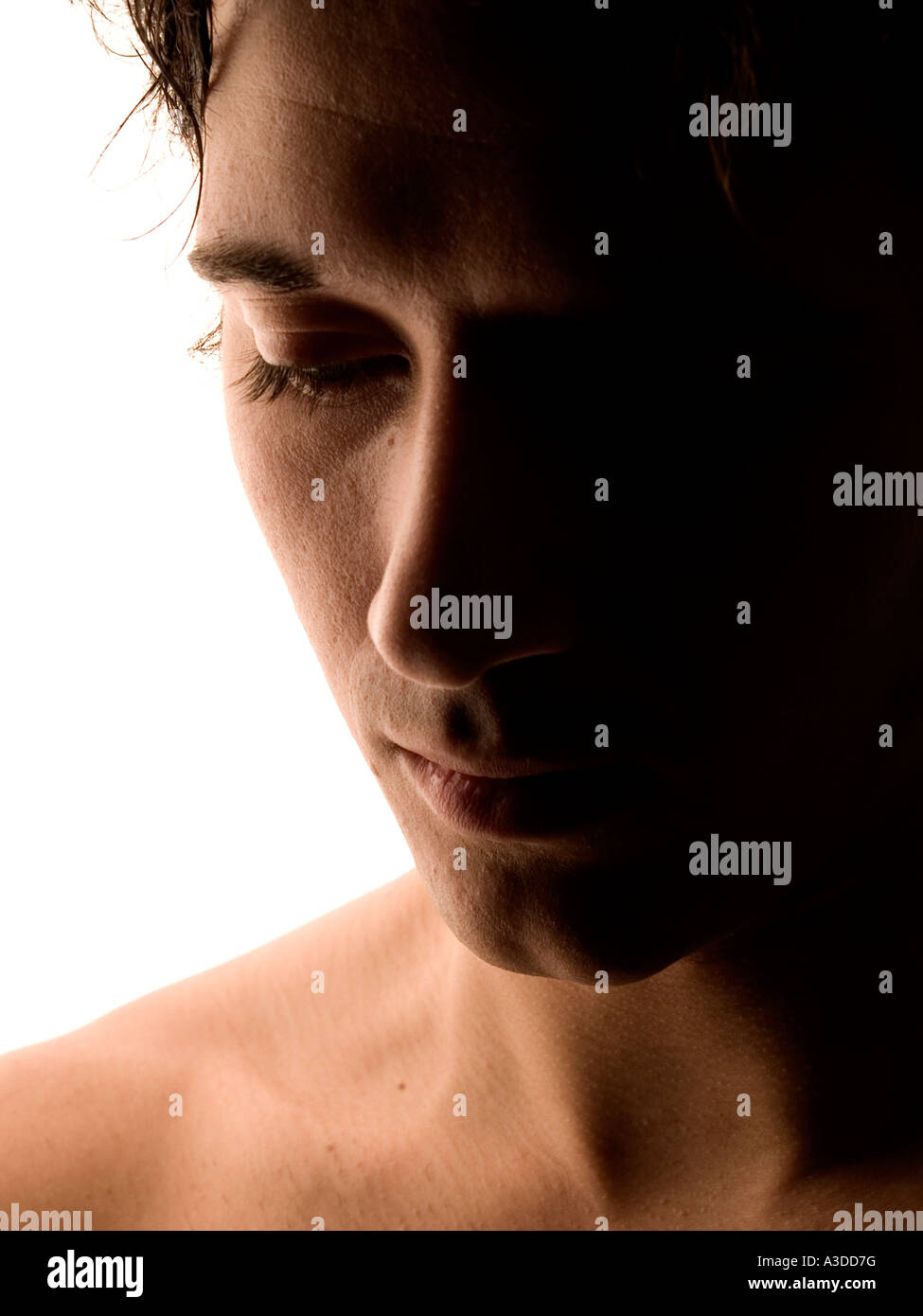 Portrait of a young thoughtful man in the backlight Stock Photo - Alamy
