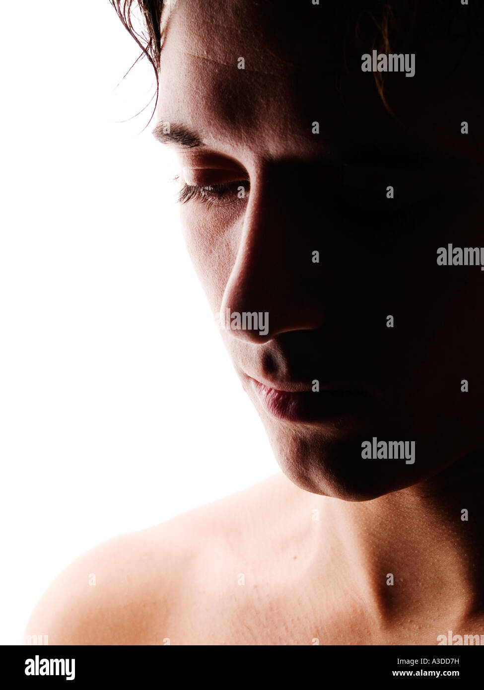 Portrait of a young thoughtful man in the backlight Stock Photo - Alamy